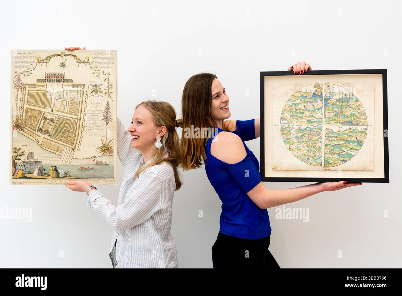 Exhibitors hold up a map of the Chelsea Physic Garden from 1753 and the ...