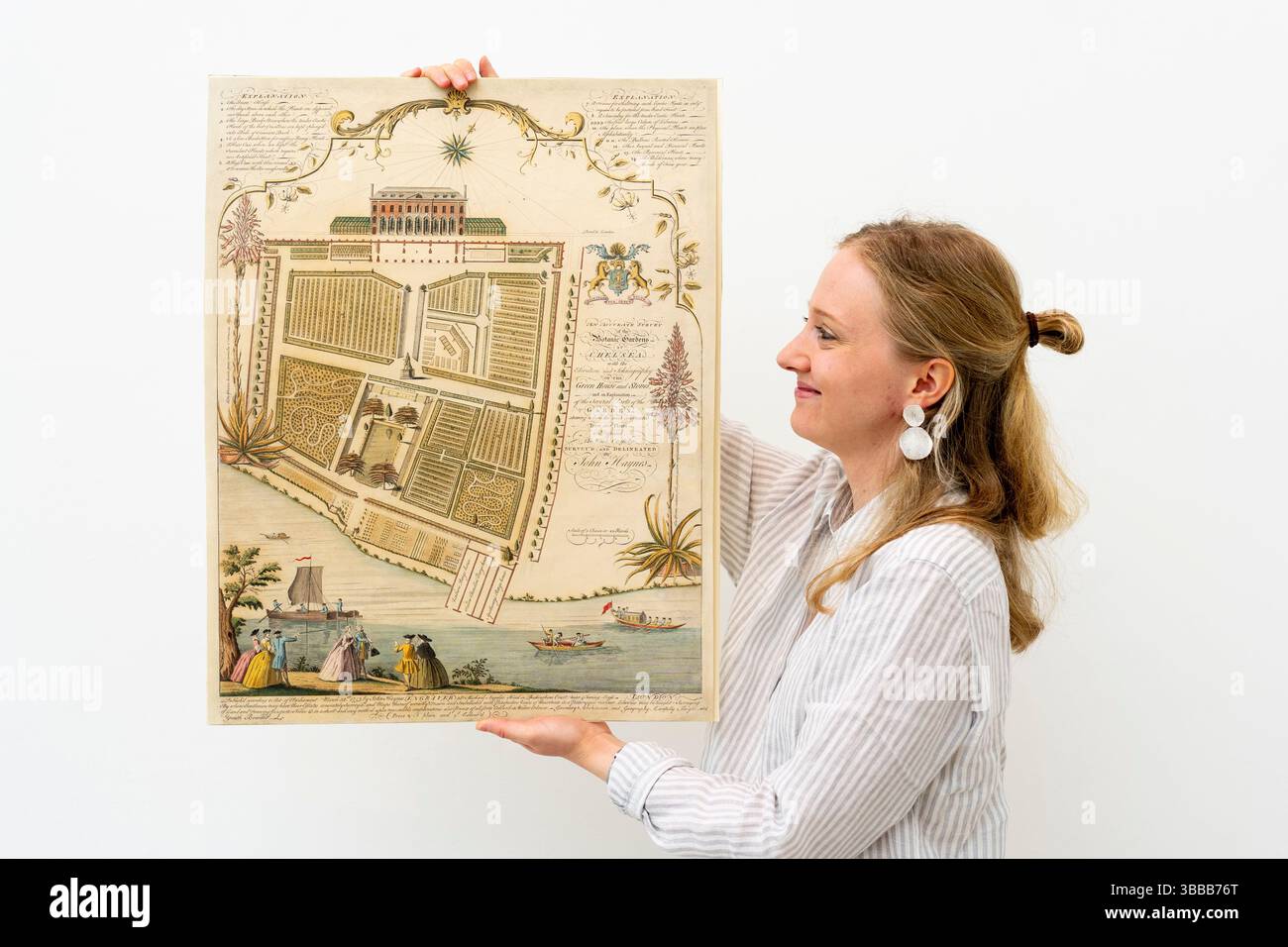 An exhibitor holds up a map of the Chelsea Physic Garden from 1753 ...