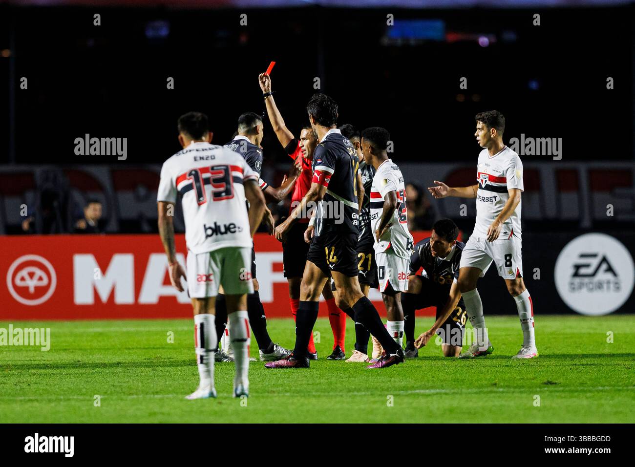 Referee Carlos Betancourt (C) shows a red card for Alisson Castro of ...