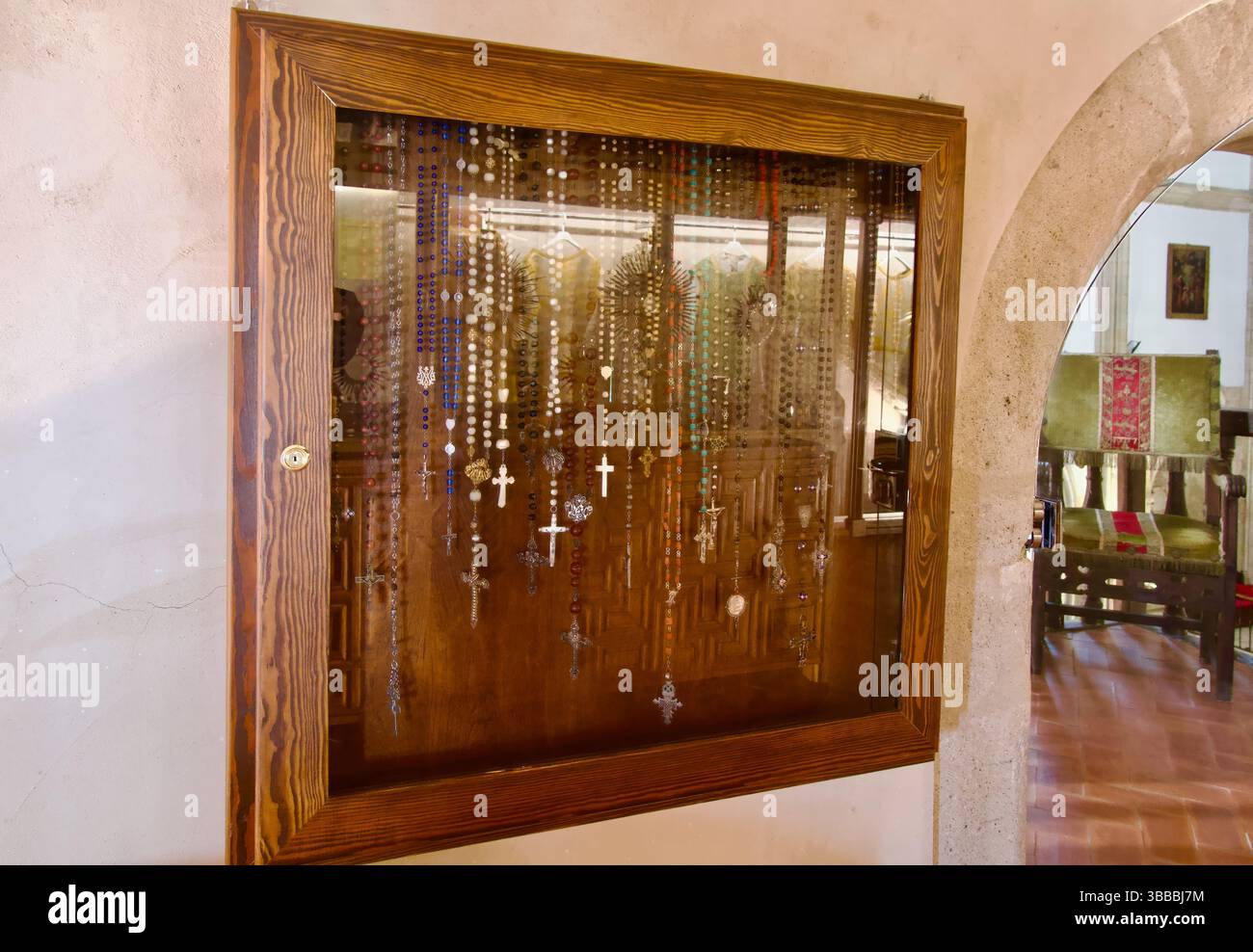 Wall display case with a collection of Catholic Rosary prayer beads ...