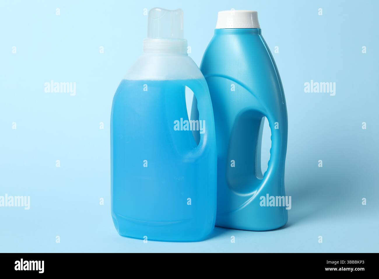 Bottles of fabric softener on light blue background Stock Photo - Alamy