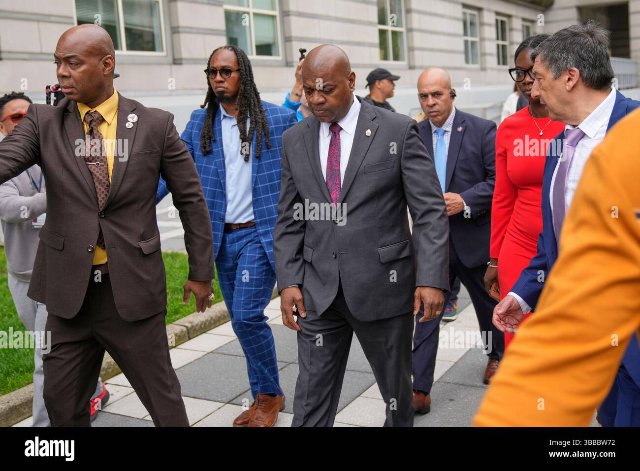 Mayor Ras Baraka, center, leaves after speaking to supporters and media ...