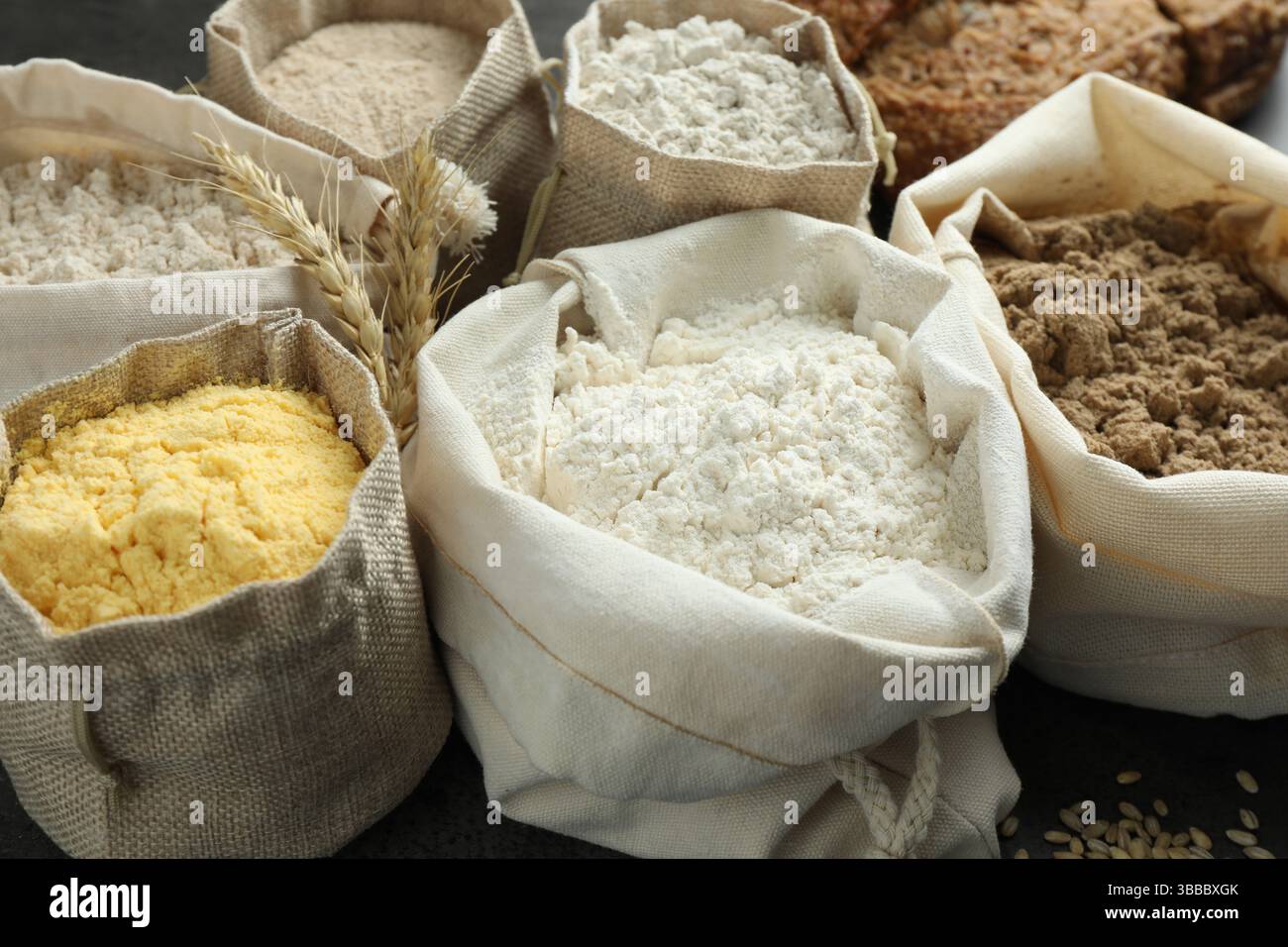 Different types of flour in bags on grey table, closeup Stock Photo - Alamy