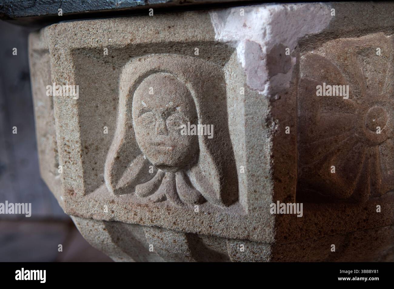 Primitive head, carved stonework from the medieval period on the ...