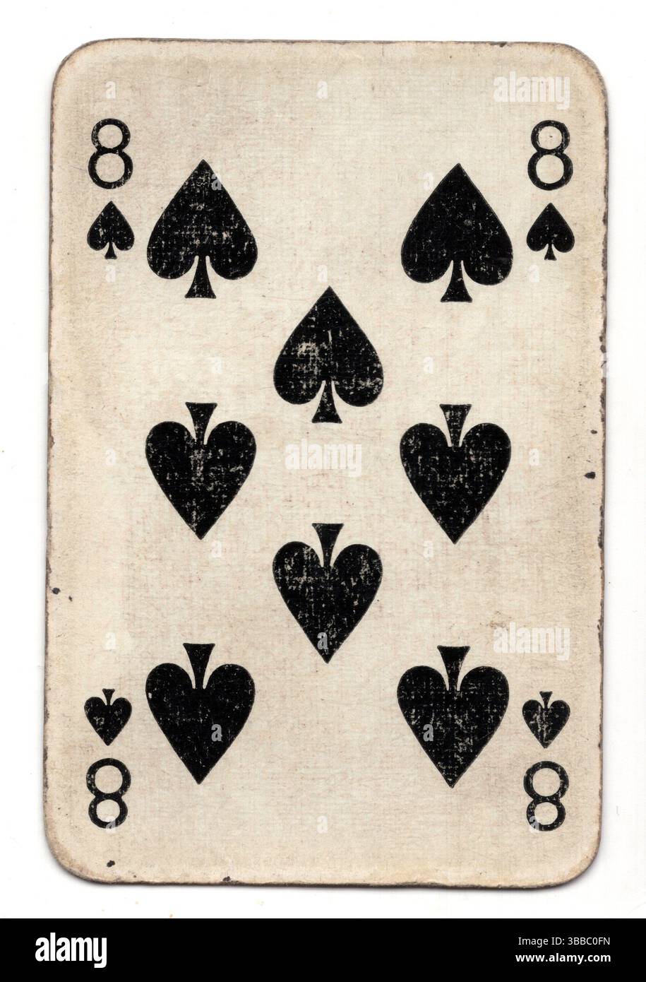 A vintage playing card in the suit of spades isolated on a white ...