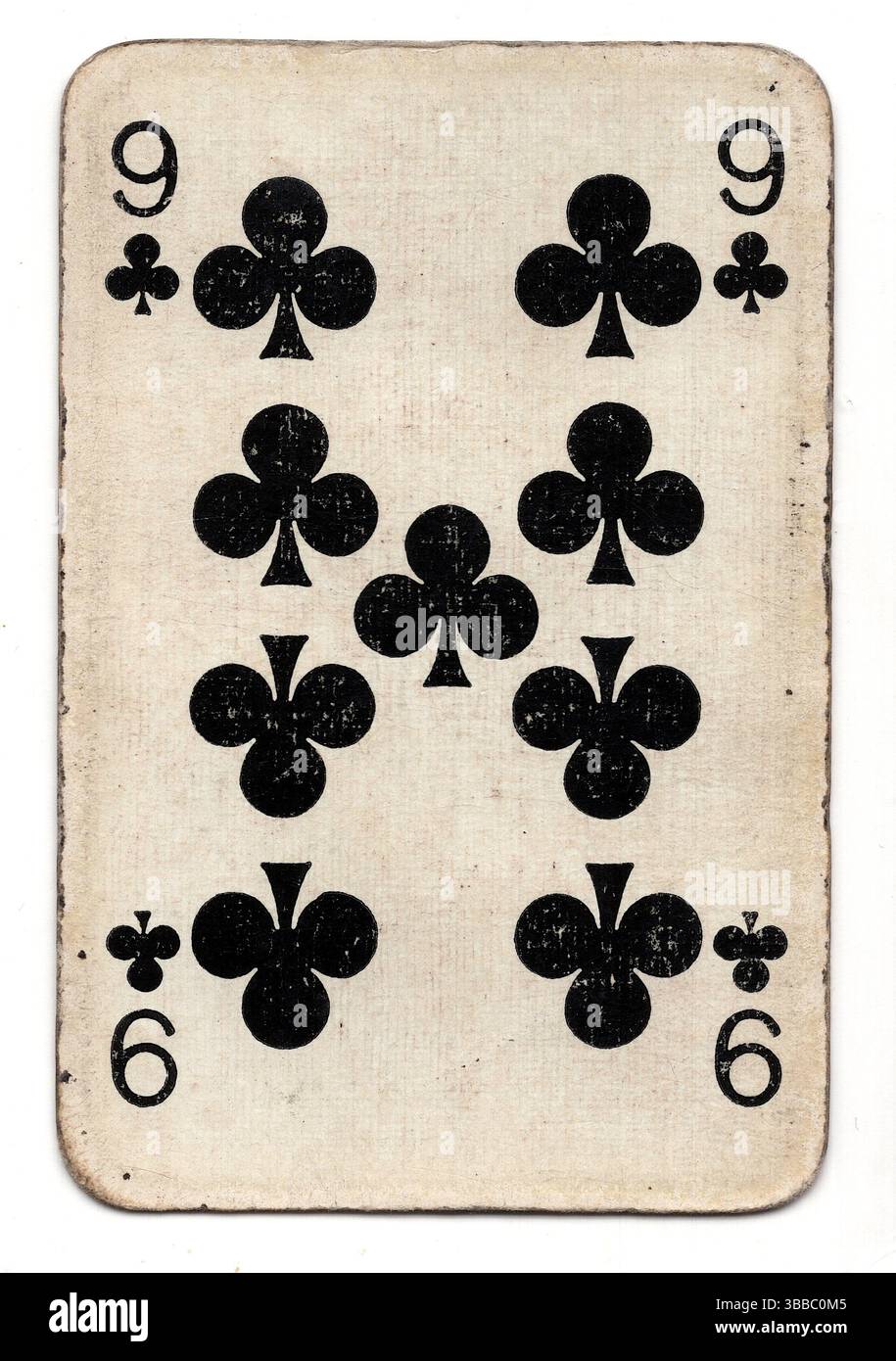 A vintage playing card in the suit of clubs isolated on a white ...