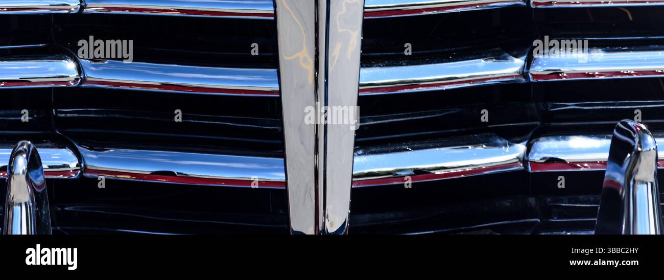 Symetrical shiny pattern from a classic car bumper with red color ...