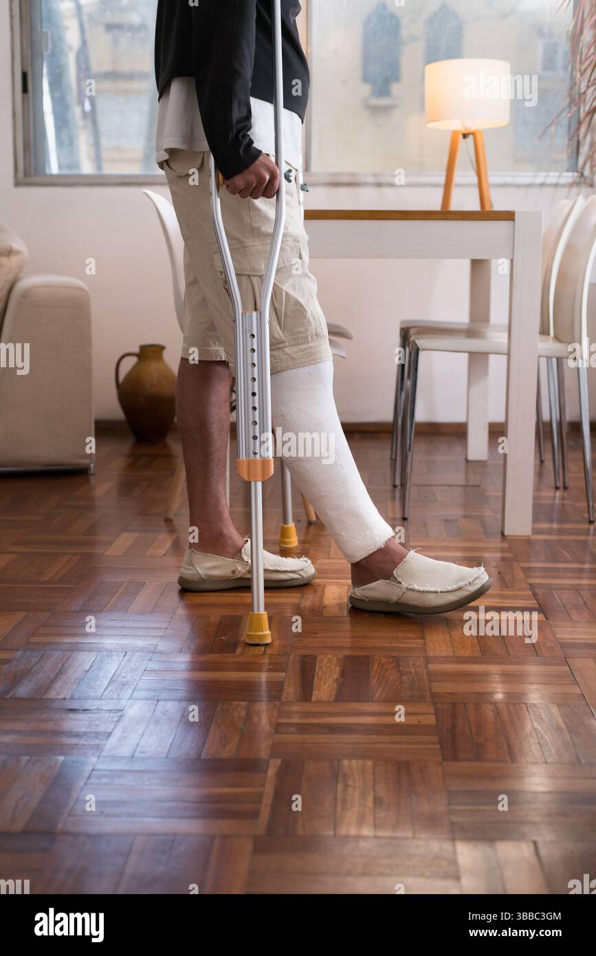 Patient using crutches to walk at home while recovering from broken leg ...