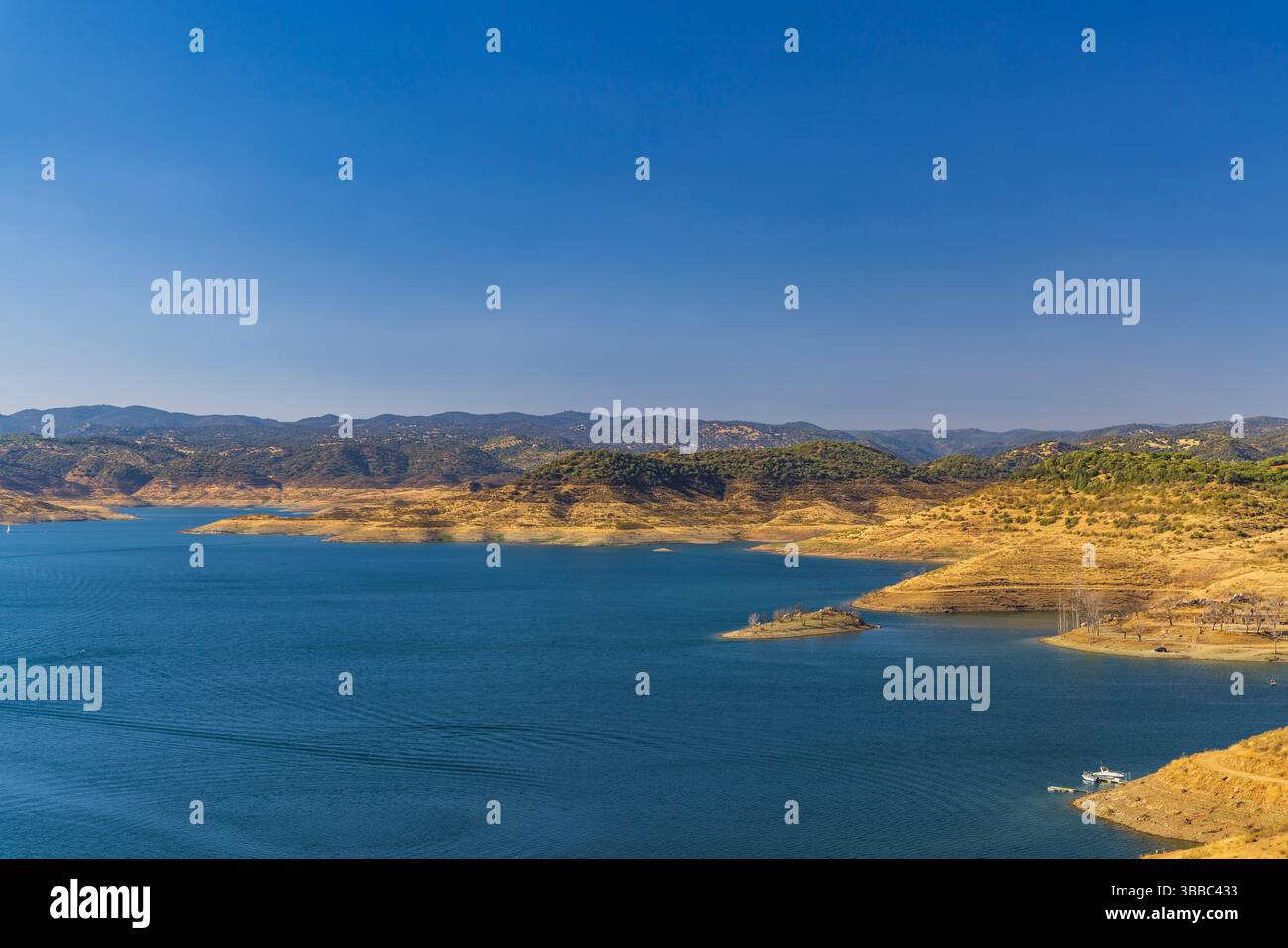 La Brena reservoir reflecting deep blue sky in Cordoba, Andalusia ...