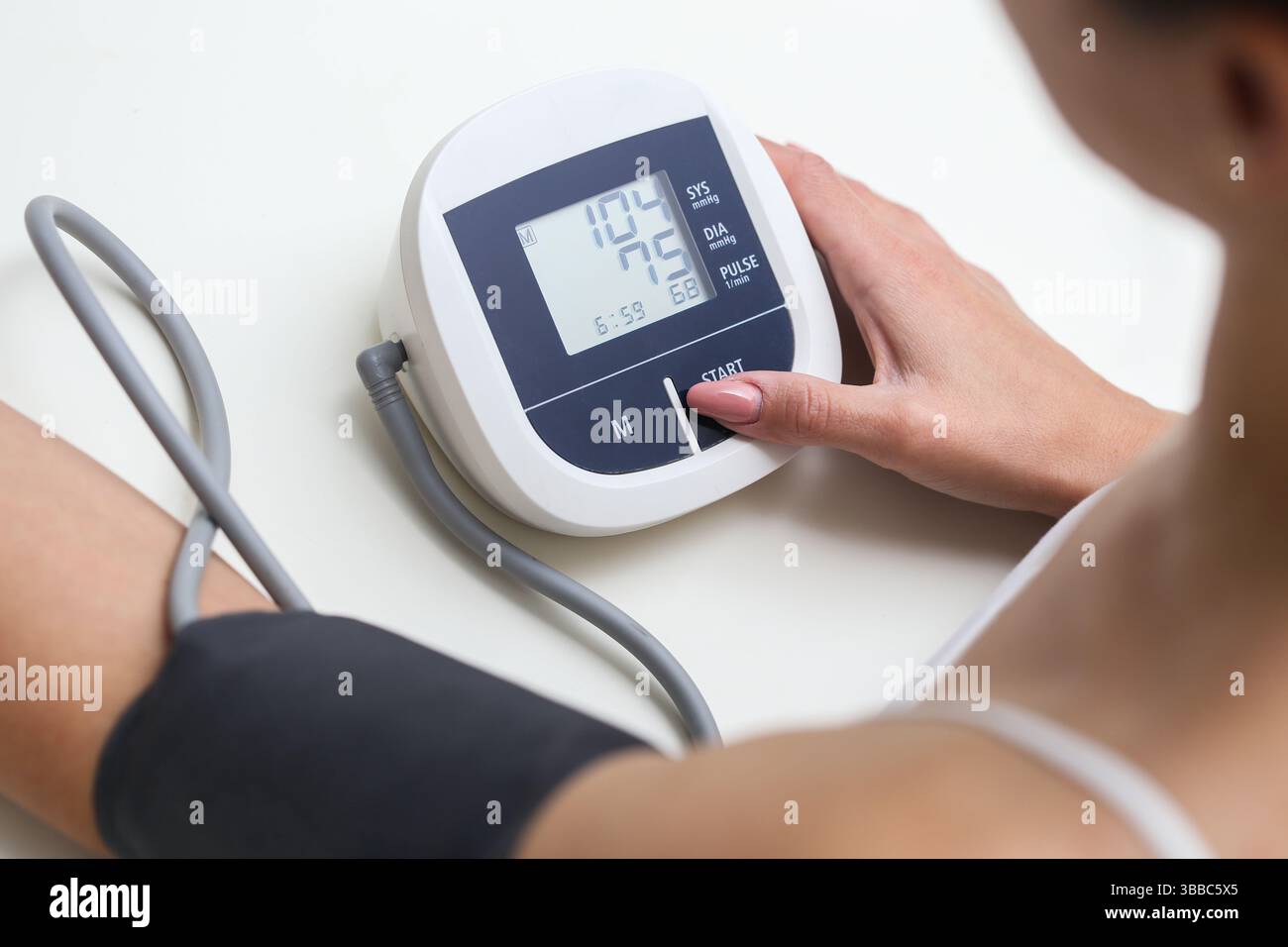 Blood pressure monitoring. Woman using digital sphygmomanometer ...