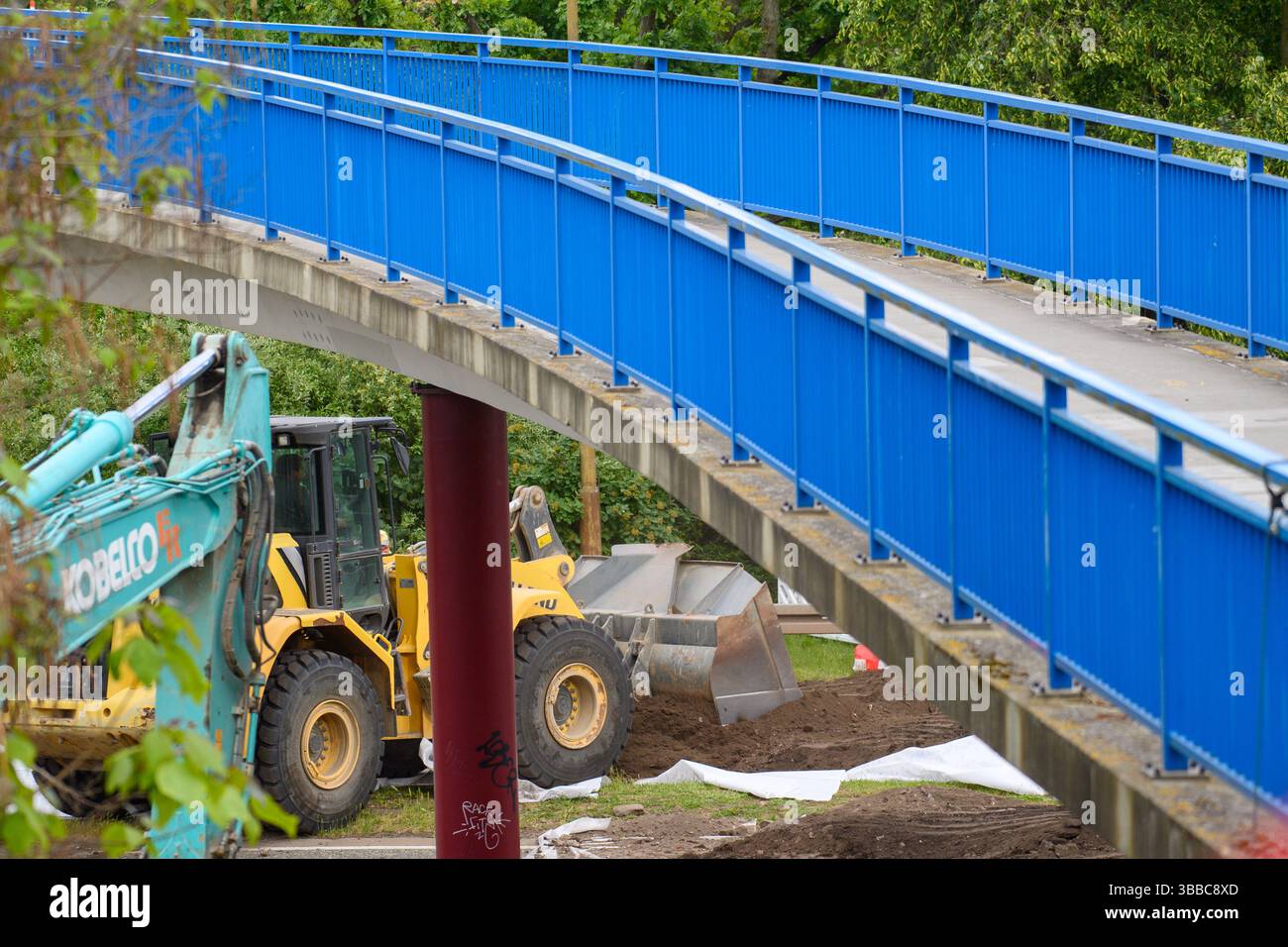 15 May 2025, Saxony-Anhalt, Magdeburg: An excavator pours earth onto ...