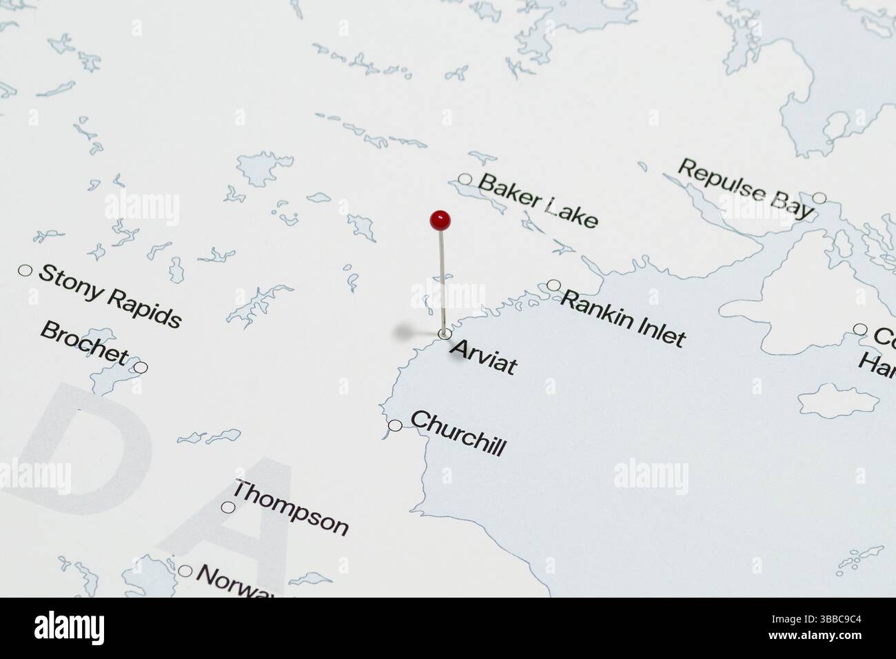 macro photo of a red pin needle into Arviat city of Canada political ...