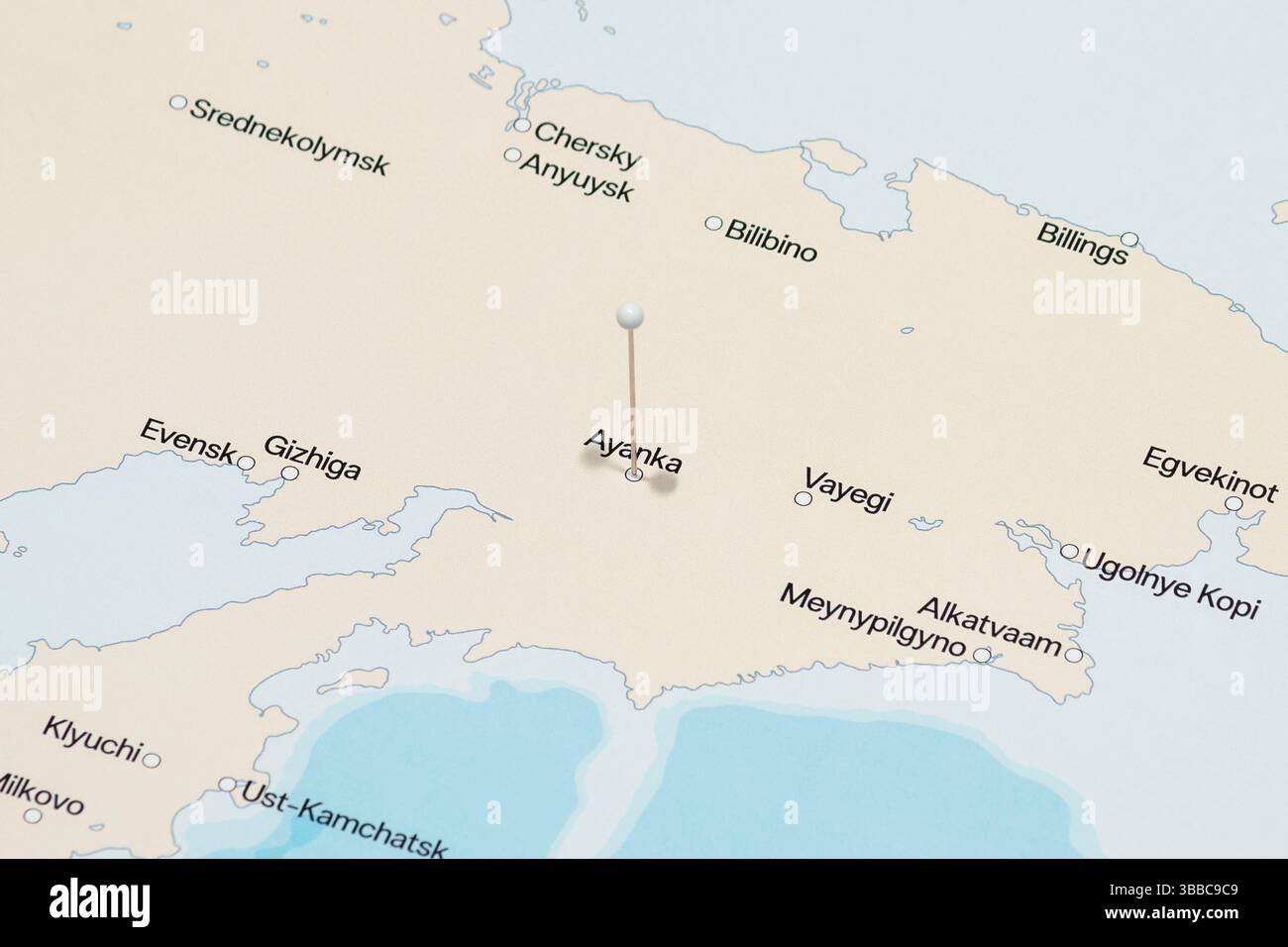 macro photo of a white pin needle into Ayanka city of Russia political ...