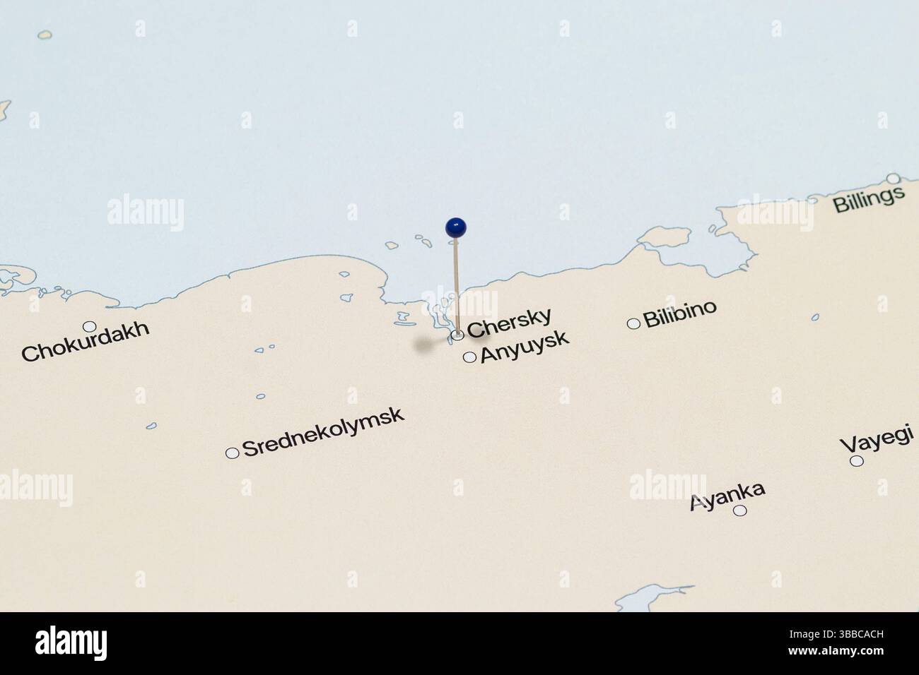 macro photo of a blue pin needle into chersky city of Russia political ...