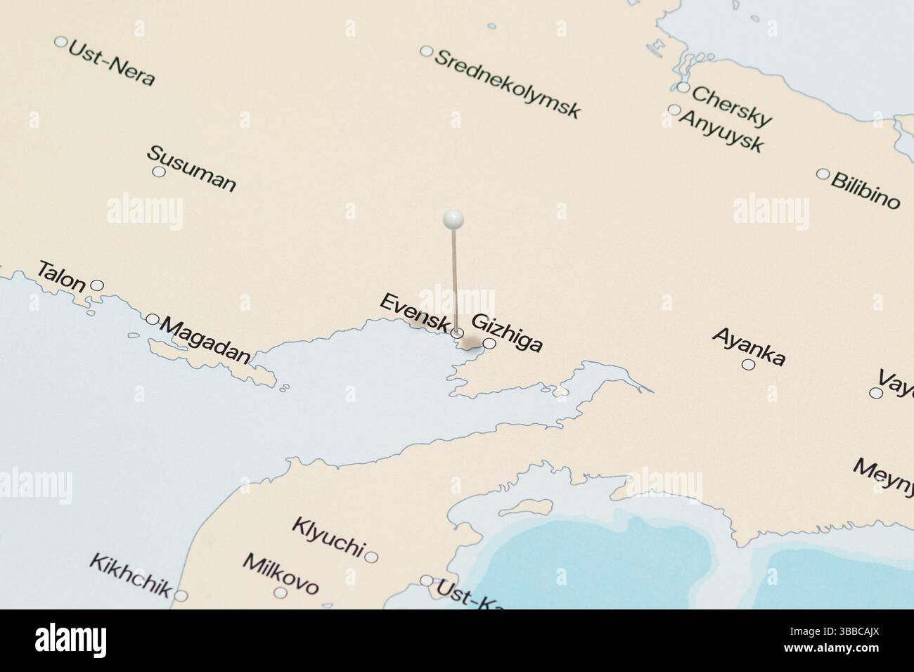 macro photo of a white pin needle into evensk city of Russia political ...