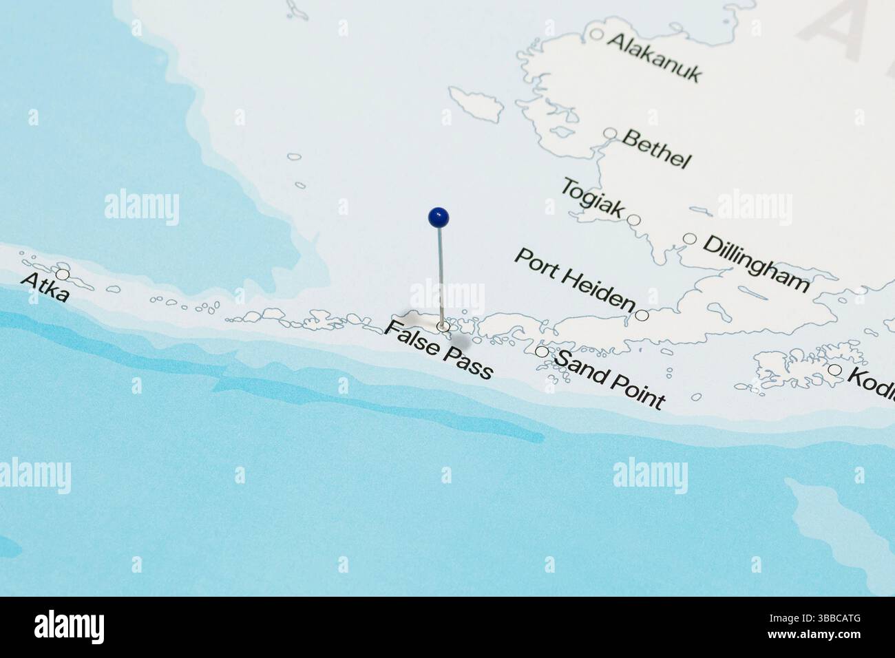 macro photo of a blue pin needle into false pass city of Alaska ...