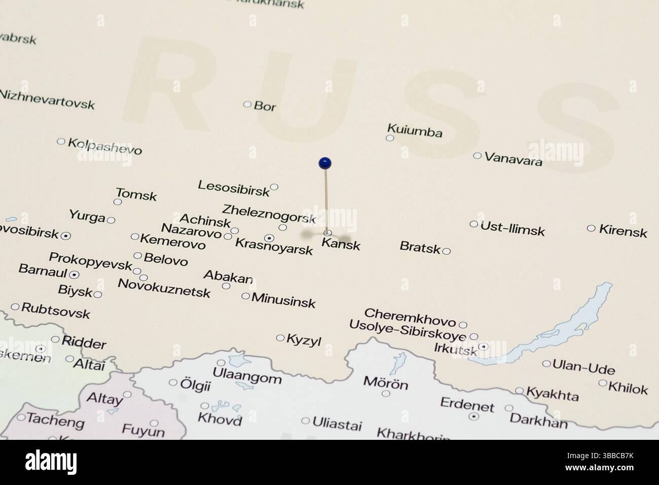 macro photo of a blue pin needle into kansk city of Russia political ...