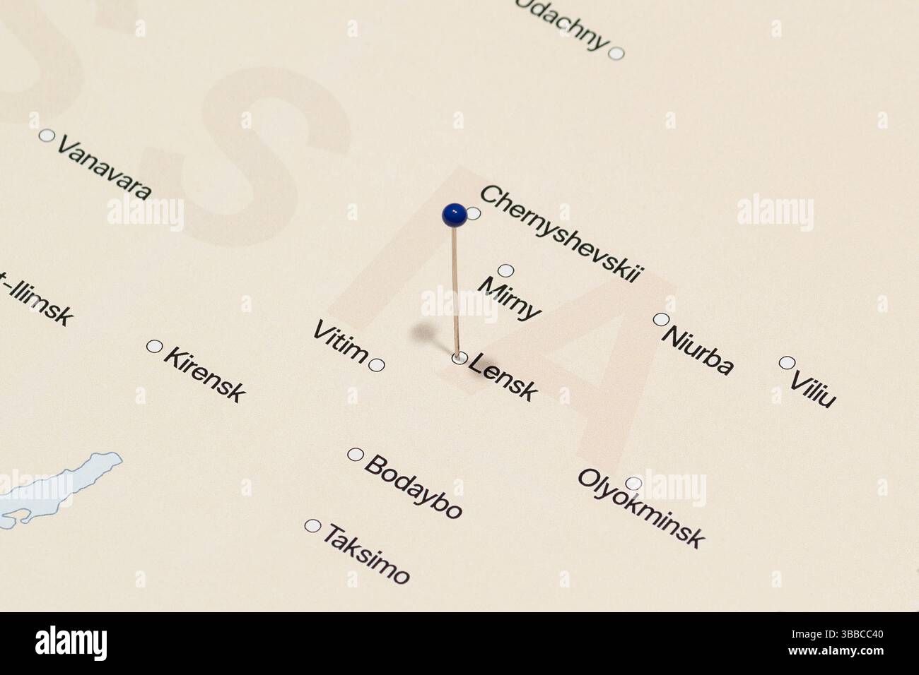 macro photo of a blue pin needle into lensk city of Russia political ...