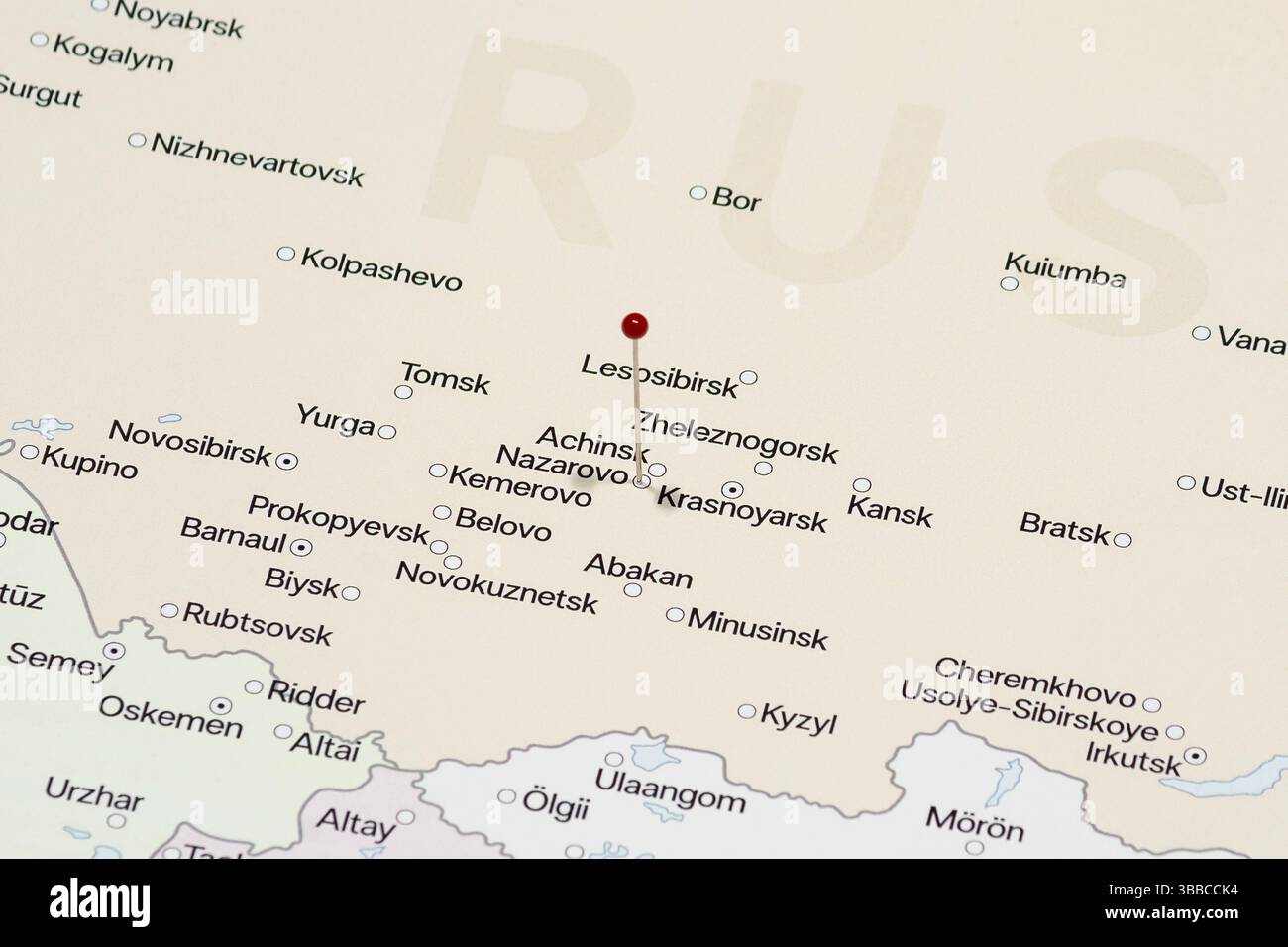 macro photo of a red pin needle into nazarovo city of Russia political ...