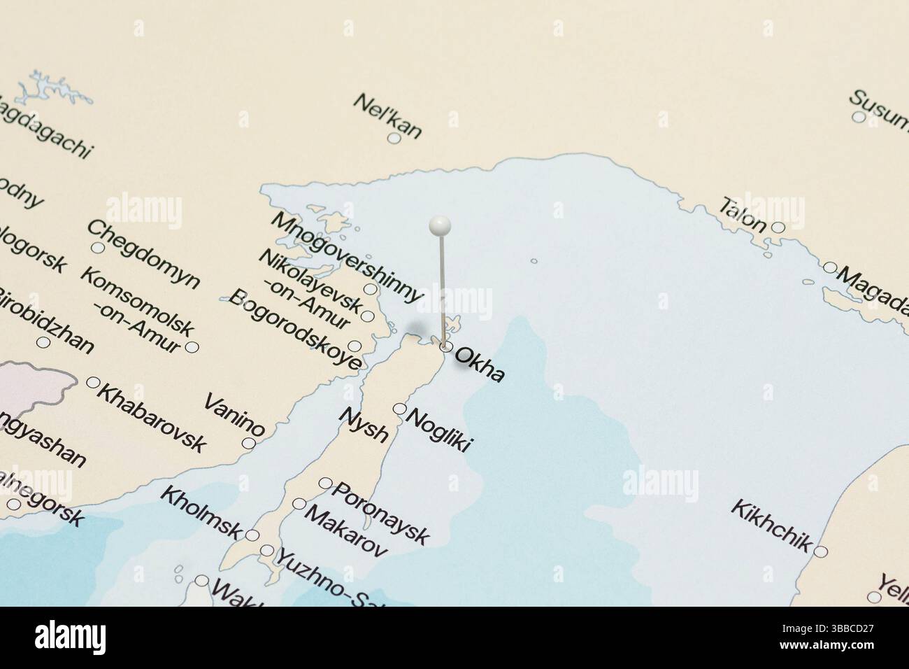 macro photo of a white pin needle into okha city of Russia political ...