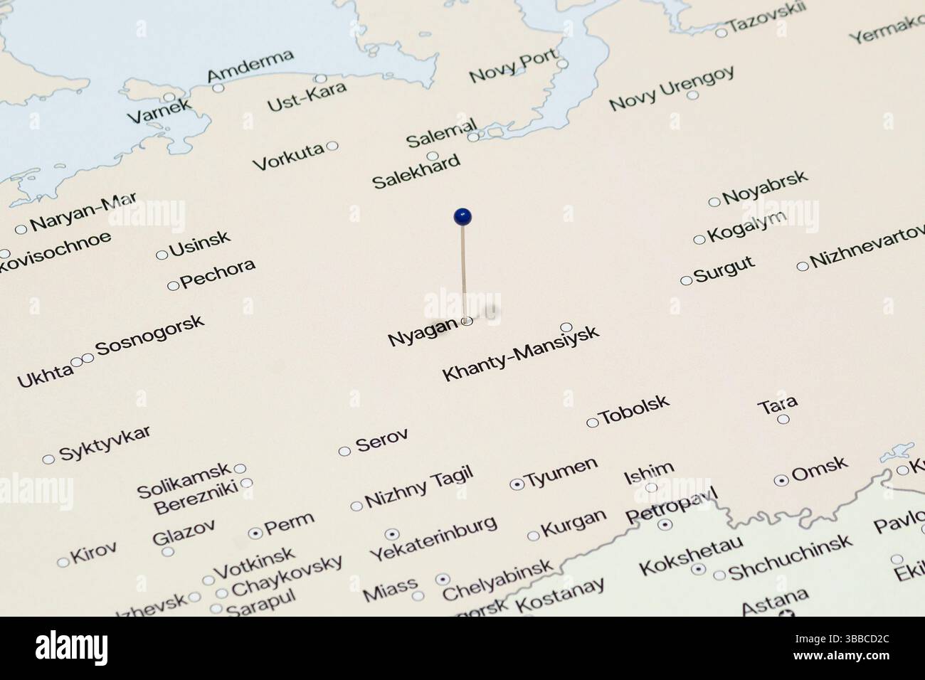 macro photo of a blue pin needle into nyagan city of Russia political ...