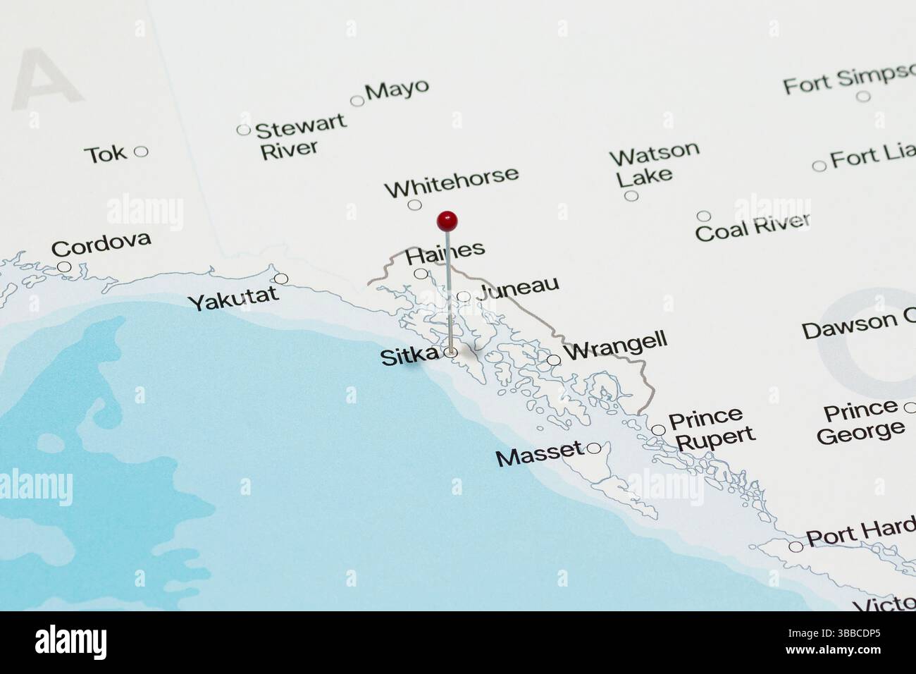 macro photo of a red pin needle into sitka city of Alaska territory of ...