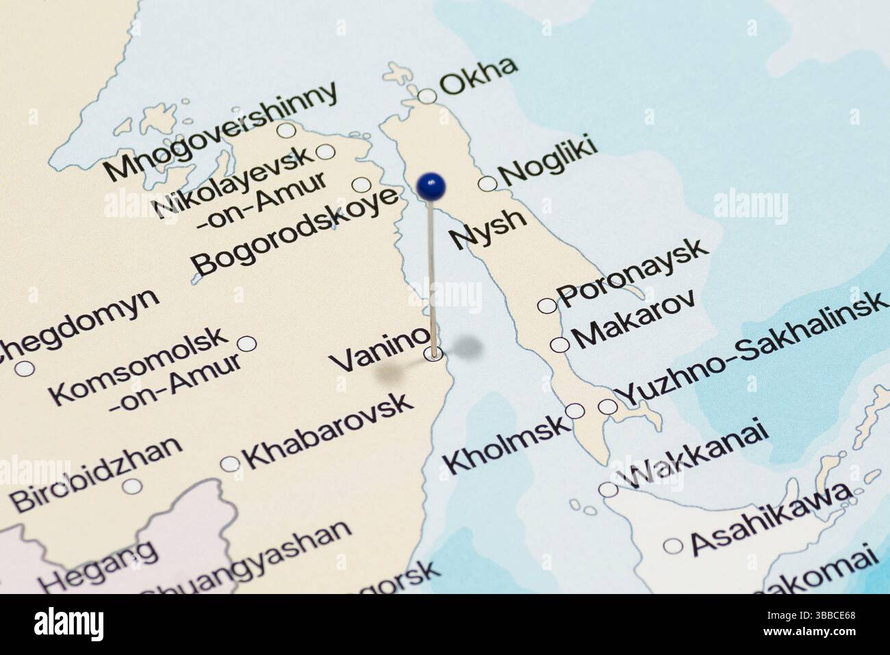 macro photo of a blue pin needle into vanino city of Russia political ...