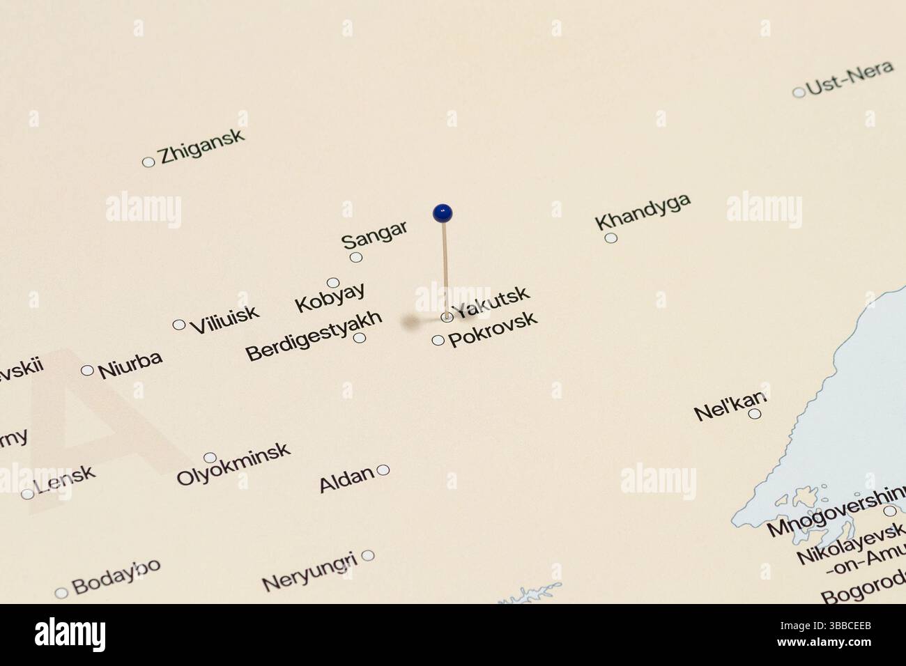 macro photo of a blue pin needle into yakutsk city of Russia political ...