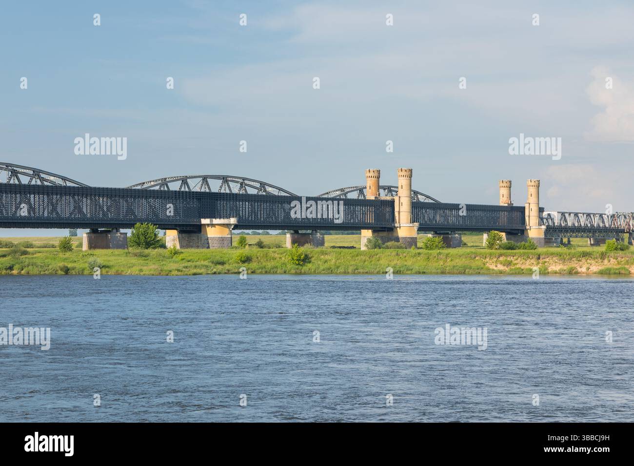 Steel railway bridge with brick towers spans the Vistula River in Tczew ...