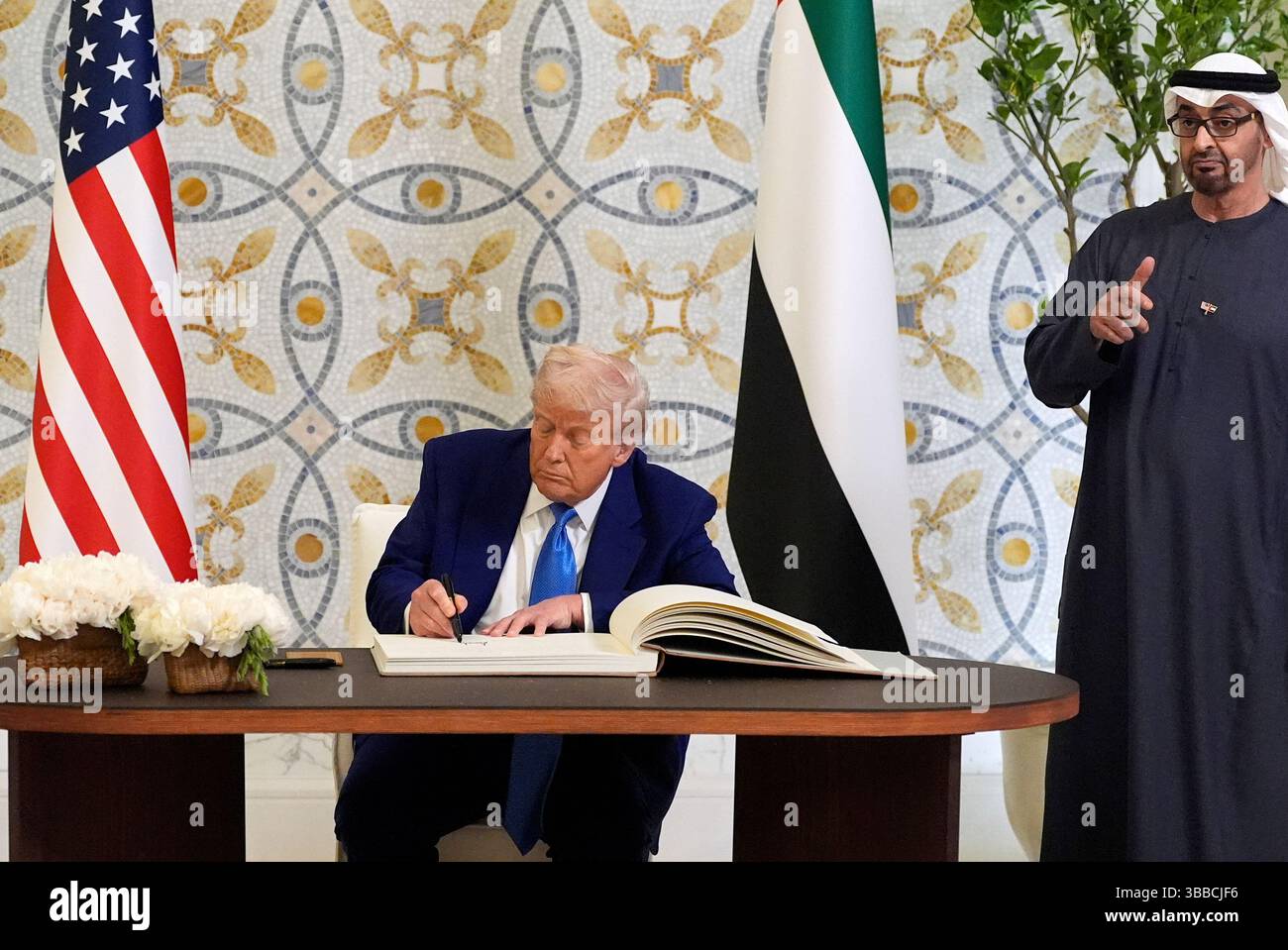 President Donald Trump signs a guest book as UAE President Mohammed bin ...