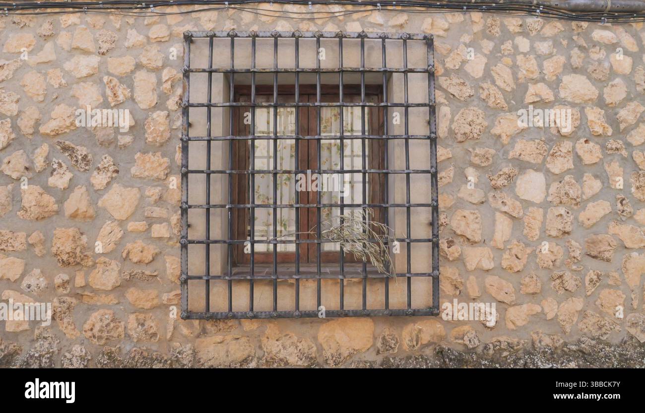 Wooden window of a rural house with iron guards. Exterior of an old ...