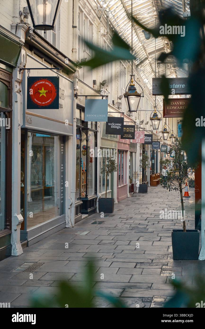 Cardiff, South Glamorgan, Wales, Europe - May 09, 2025: A row of shops in Royal Arcade paved ...