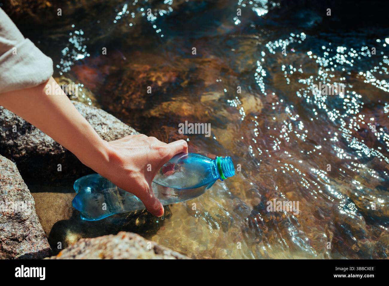 Woman draws clean spring water into a plastic bottle Stock Photo - Alamy