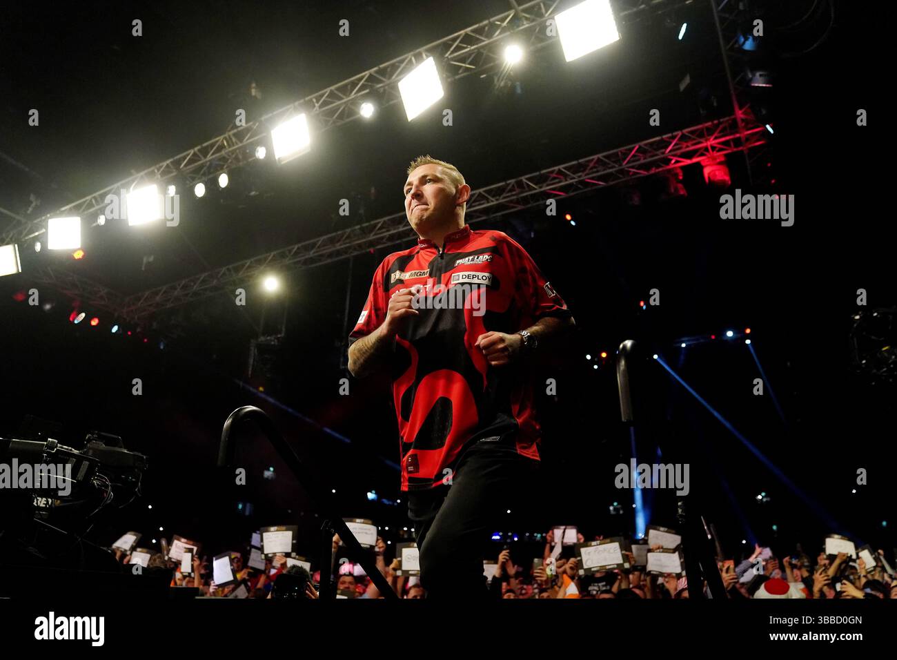 Nathan Aspinall walks out to play Michael van Gerwen (not pictured) on ...