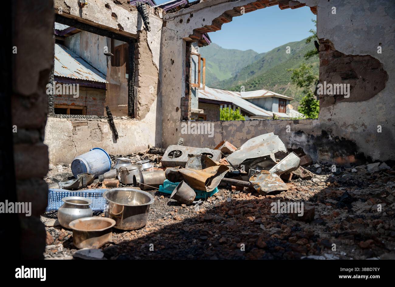 Damaged utensils are seen inside a house destroyed in cross-border ...