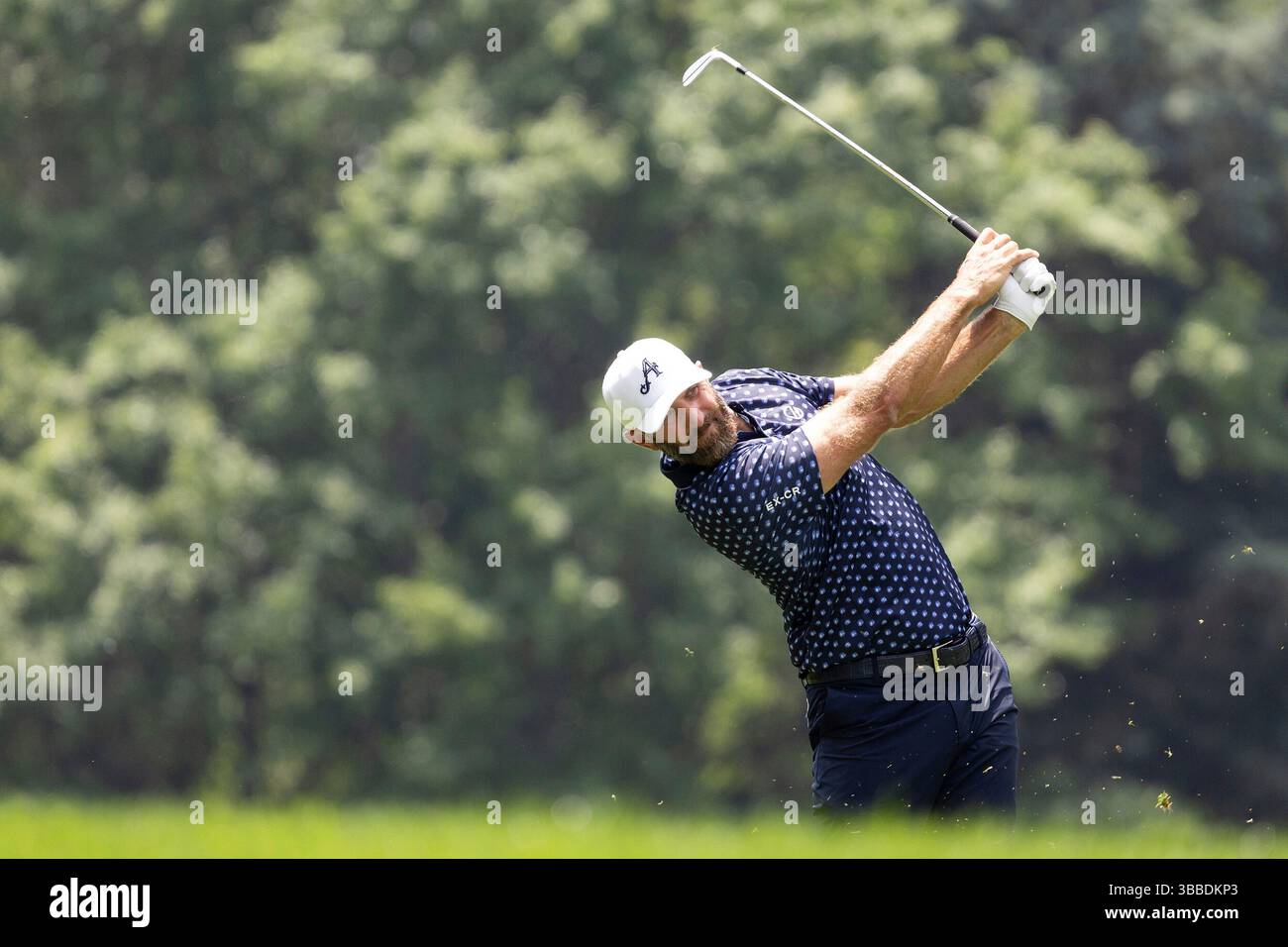 Captain Dustin Johnson of 4Aces GC hits his shot during the first round ...