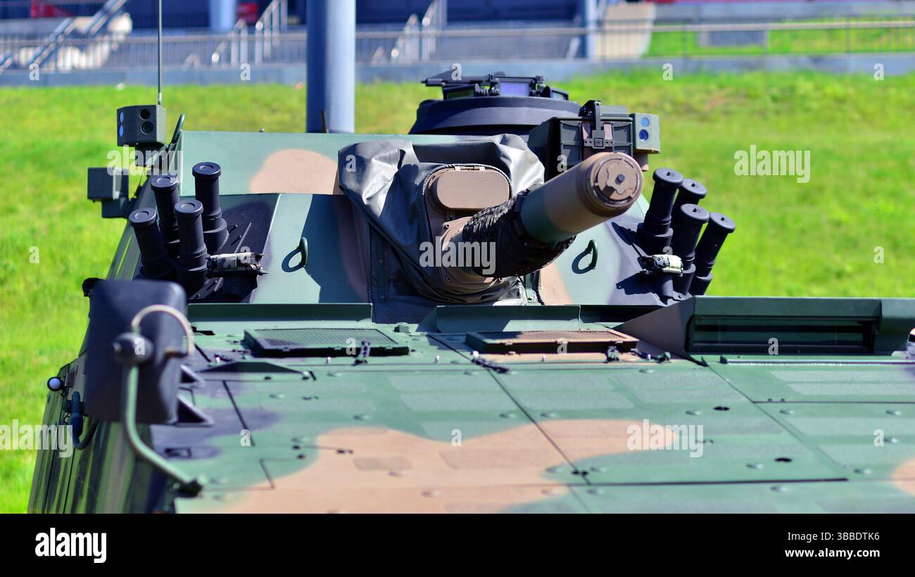 Heavy military tank vehicle turret gun aiming on a target and ready to ...