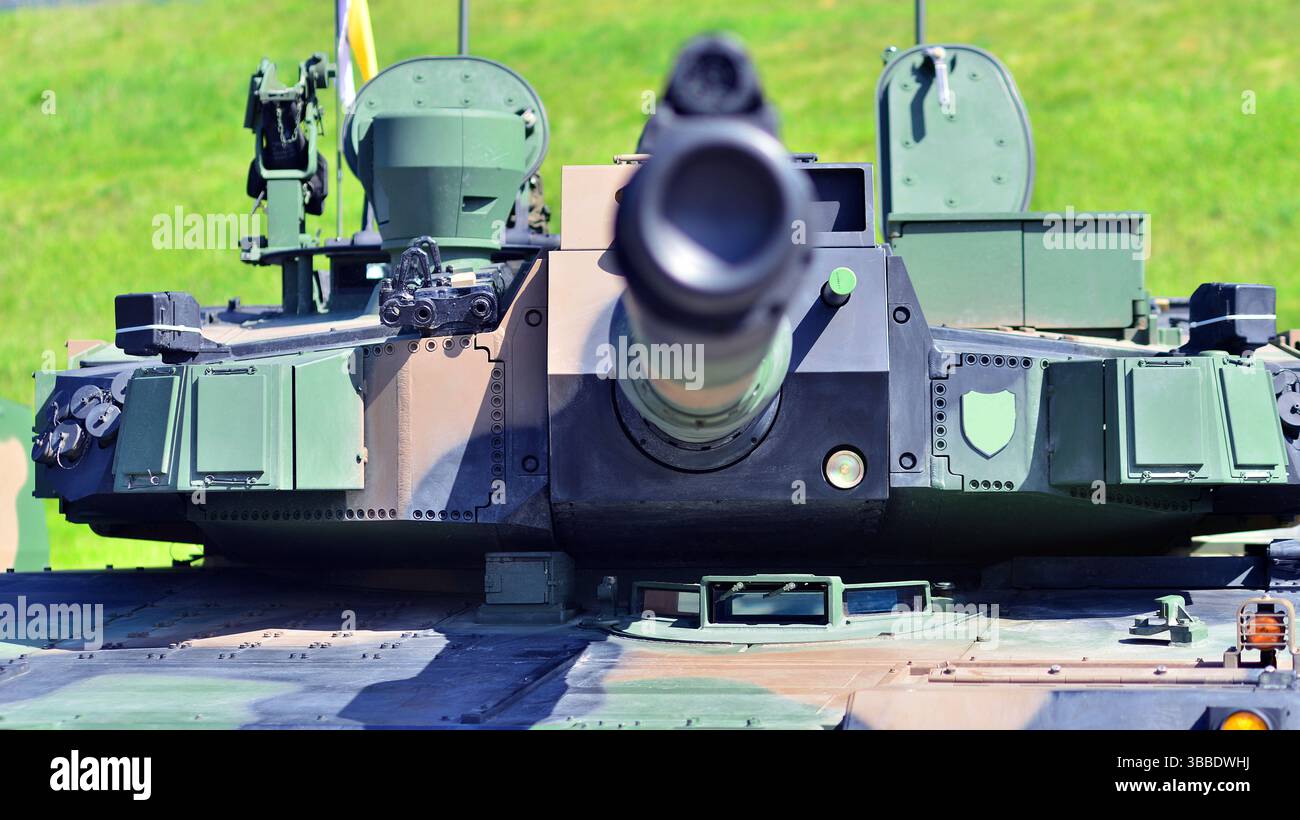 Heavy military tank vehicle turret gun aiming on a target and ready to ...