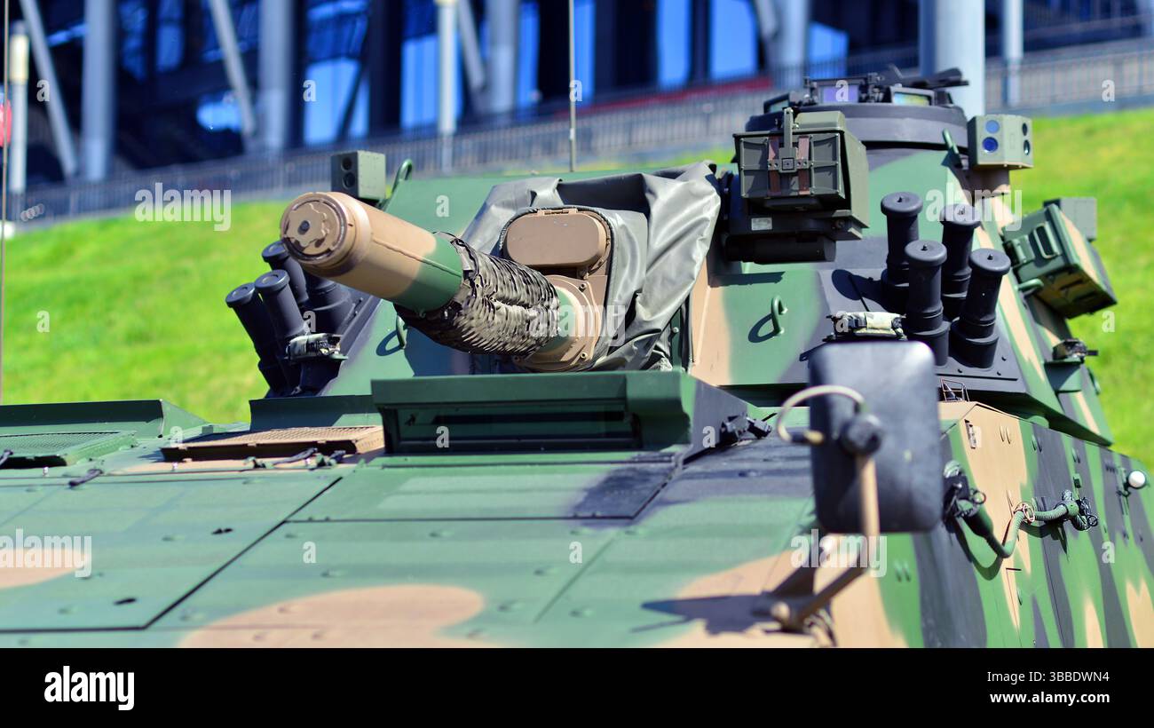 Heavy military tank vehicle turret gun aiming on a target and ready to ...