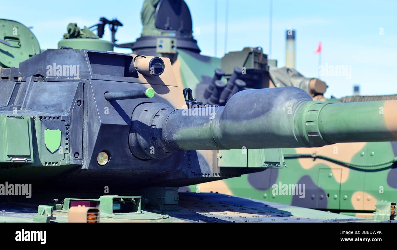 Heavy military tank vehicle turret gun aiming on a target and ready to ...