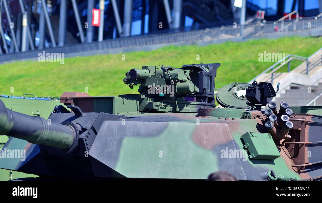 Heavy military tank vehicle turret gun aiming on a target and ready to fire. The rotating turret ...