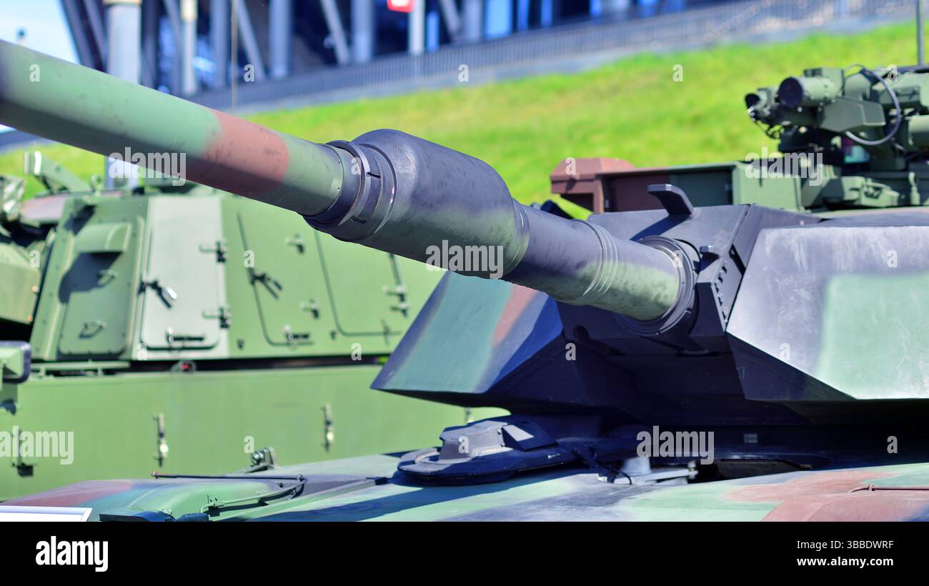 Heavy military tank vehicle turret gun aiming on a target and ready to ...