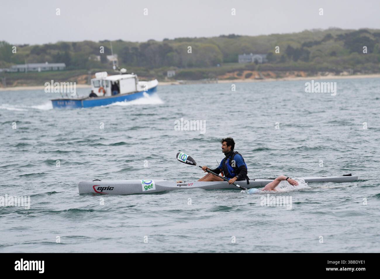 Kayaker Nicholas Burden guides endurance swimmer Lewis Pugh as a ...