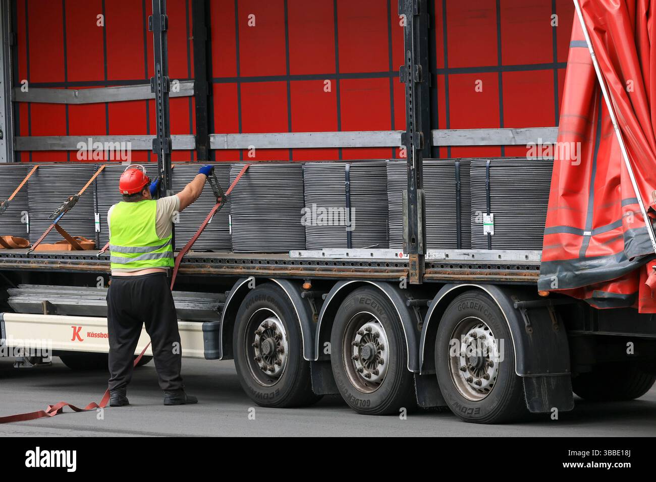 Riesa, Germany. 15th May, 2025. A truck driver secures coils of ...