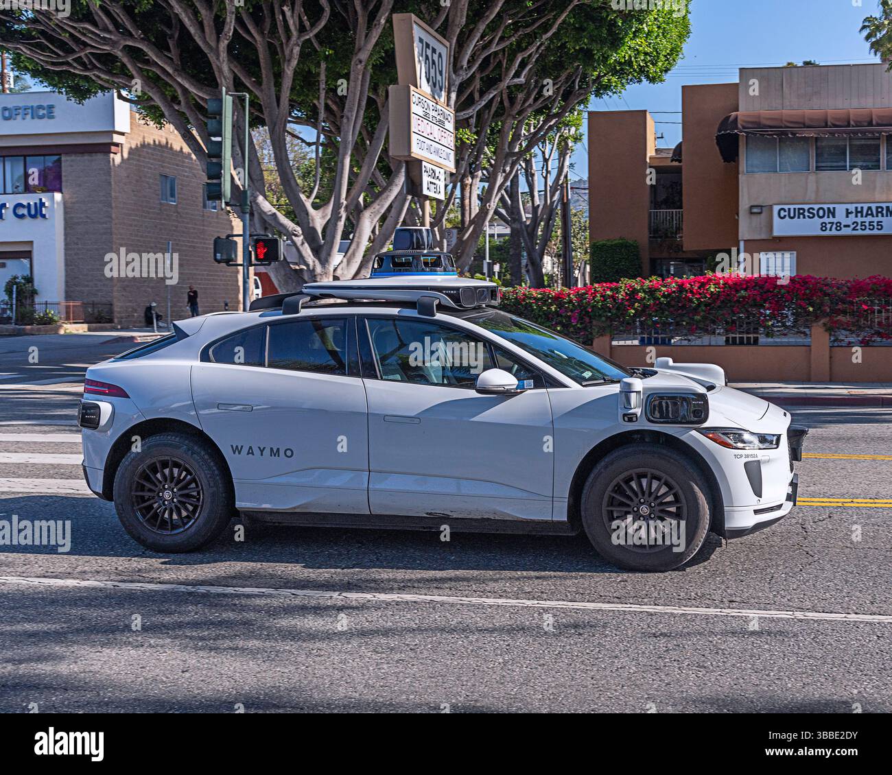 Los Angeles, CA, USA: May 15, 2025: Waymo, a self-driving car, drives ...