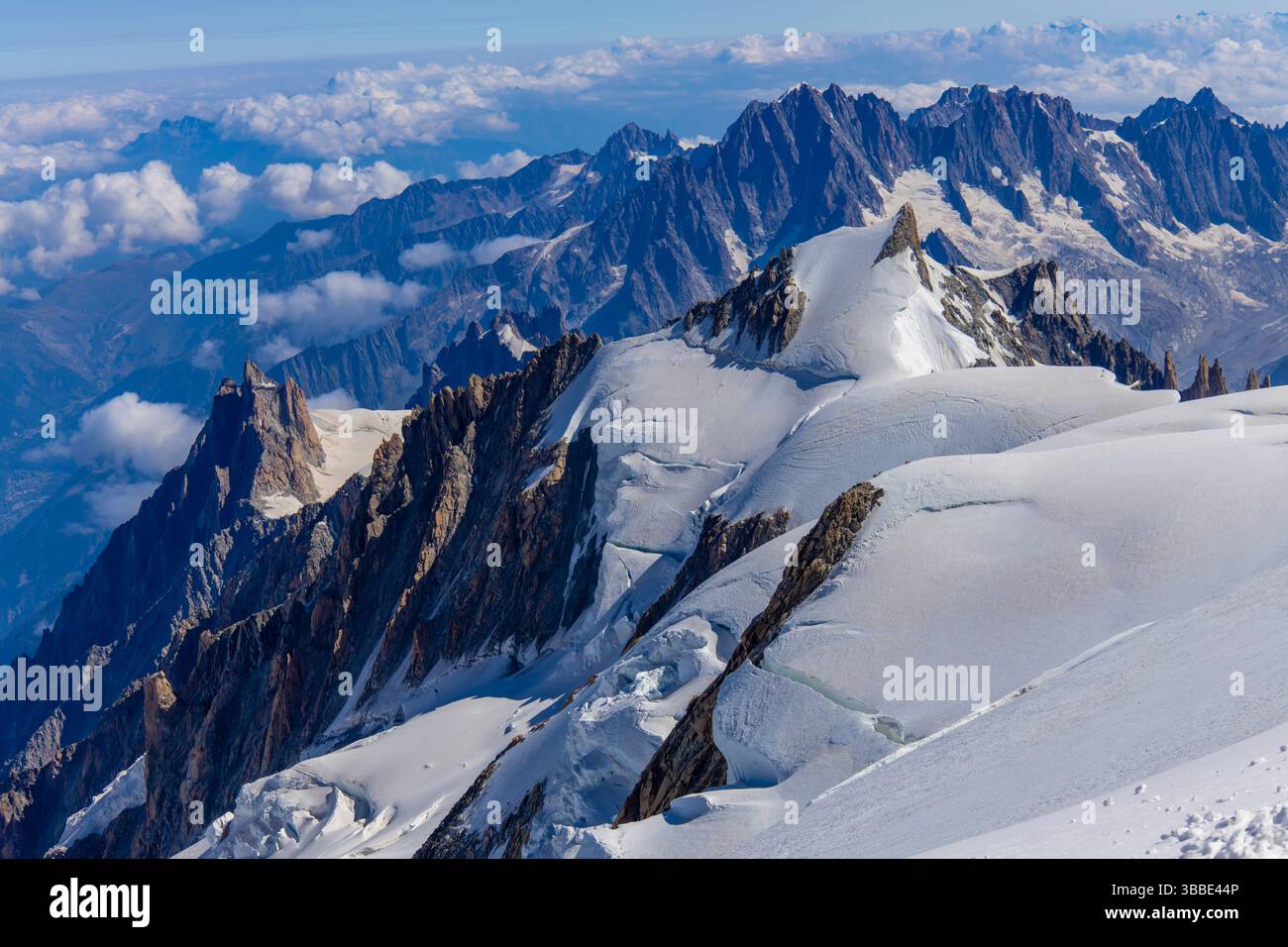 Aiguille du Midi peak above the clouds from the ascent to the summit of Montblanc view. Snow ...
