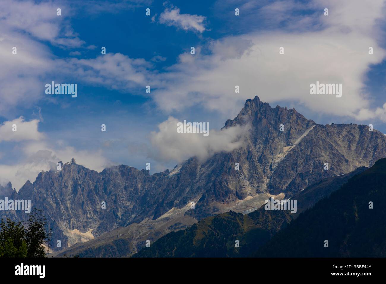 Aiguille du Midi peak above the clouds from the ascent to the summit of Montblanc view. Snow ...