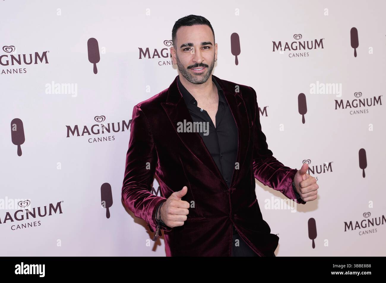 Adil Rami poses for photographers upon arrival at the Magnum Cannes ...