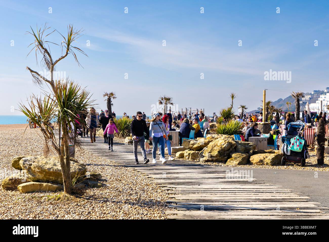 People walking along the beach boardwalk and The Pilot Beach Bar ...