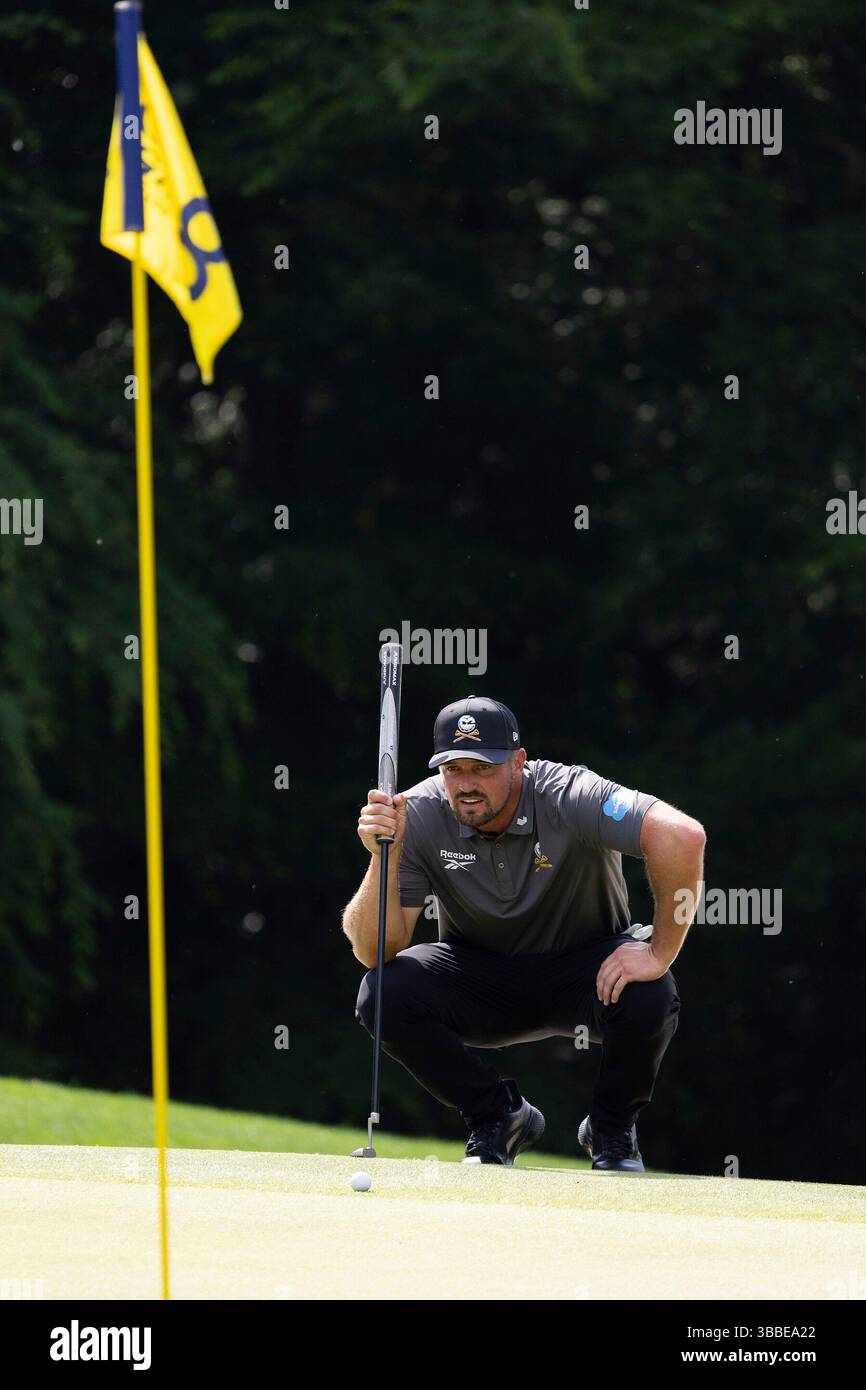 Captain Bryson DeChambeau of Crushers GC reads his putt on the eighth ...